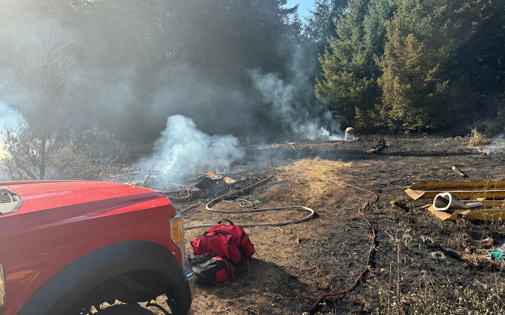 Field fire limited to 1 acre off Ervin Road burns structures, vehicles ...